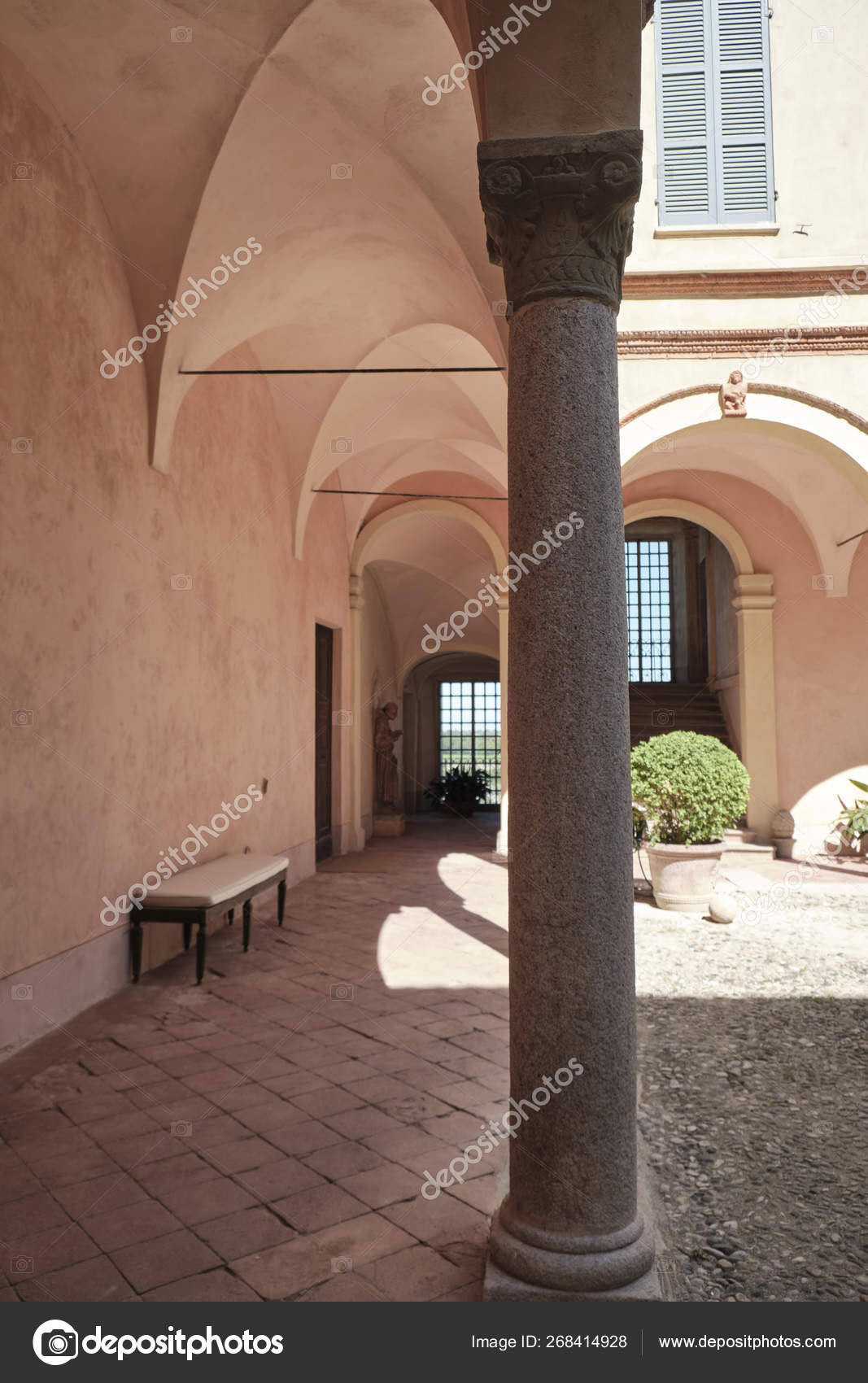 Courtyard with columns and arch of Rivalta castle and landscape ...