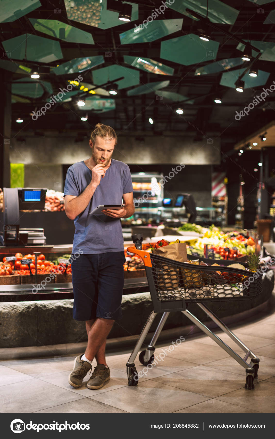 Young Man Trolley Full Products Thoughtfully Using Tablet Reading ...