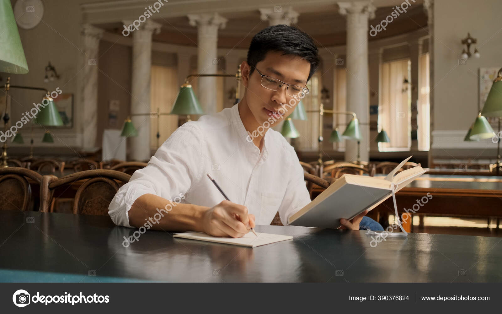 Attractive Asian Male Student Textbook Thoughtfully Making Study Notes ...