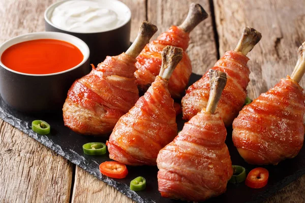 Traditional Lollipops chicken legs wrapped in bacon served with - Stock ...