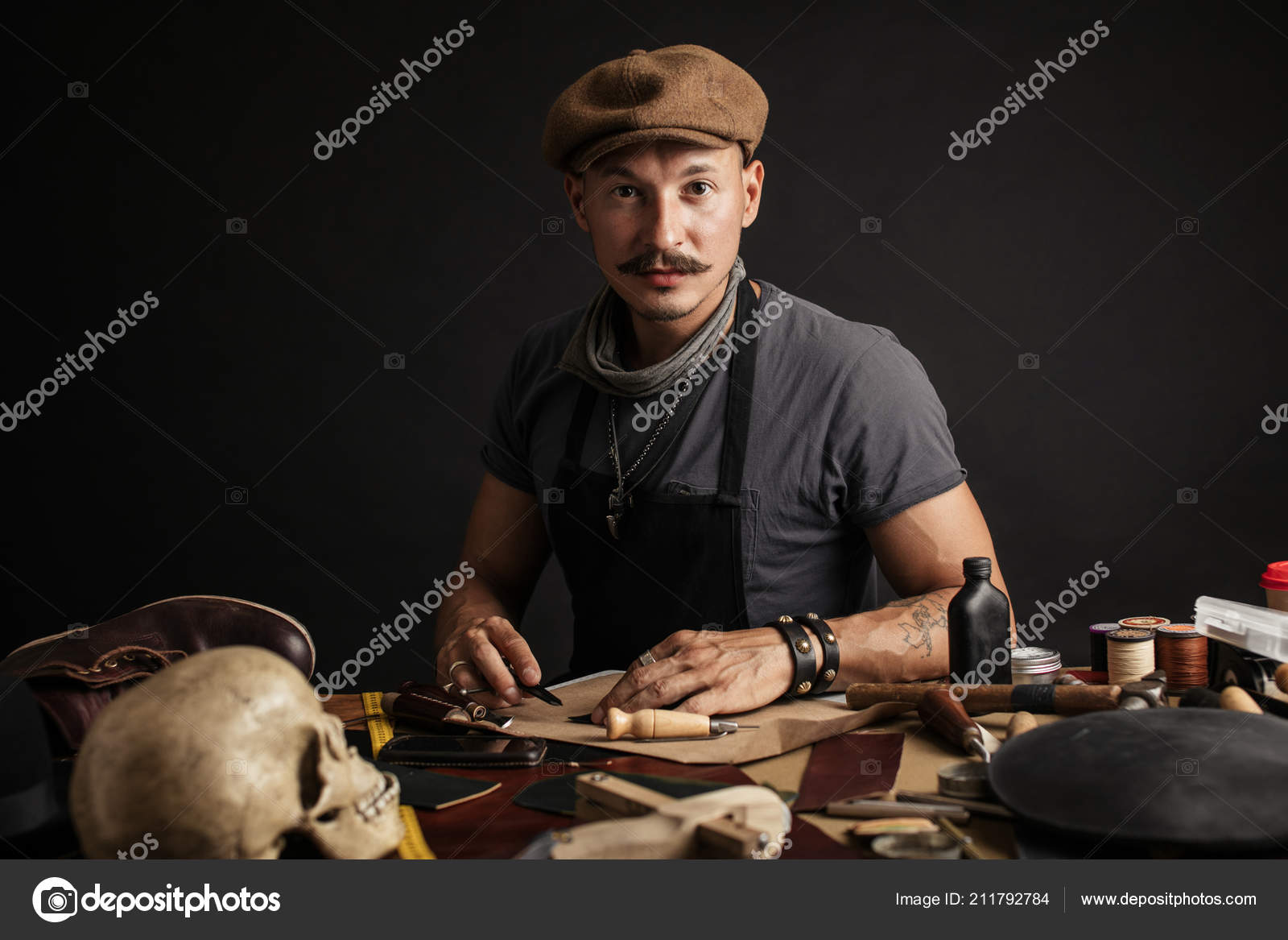 Professional shoemaker in his workshop making and repairing custom made ...
