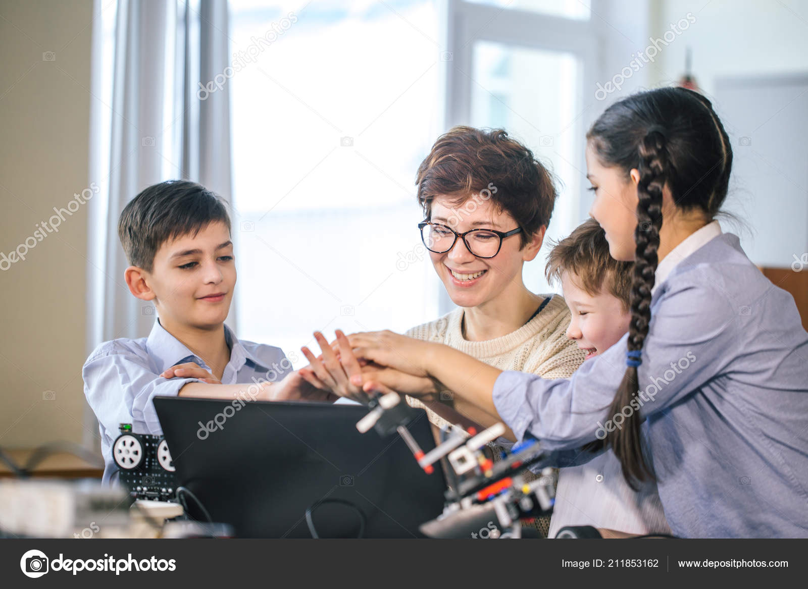 Happy children learn programming using laptops on extracurricular ...