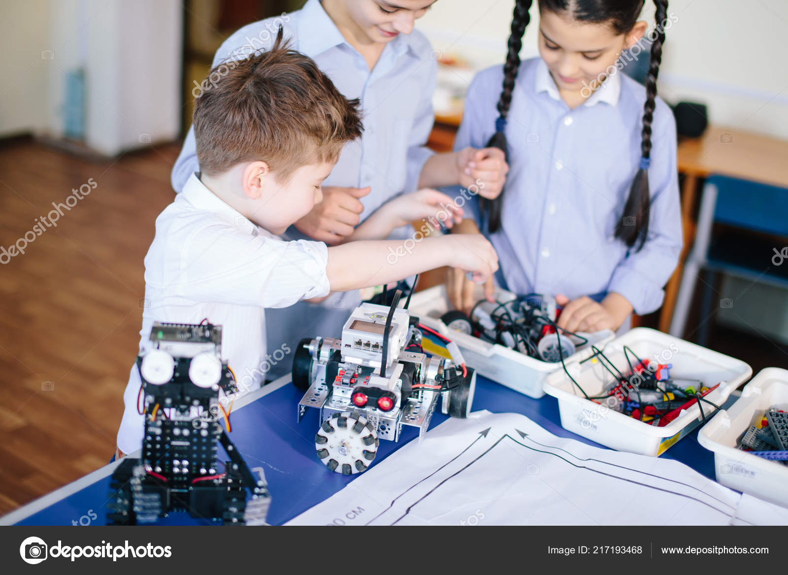 Kids playing with electrical robot while visiting robotics exhibition ...