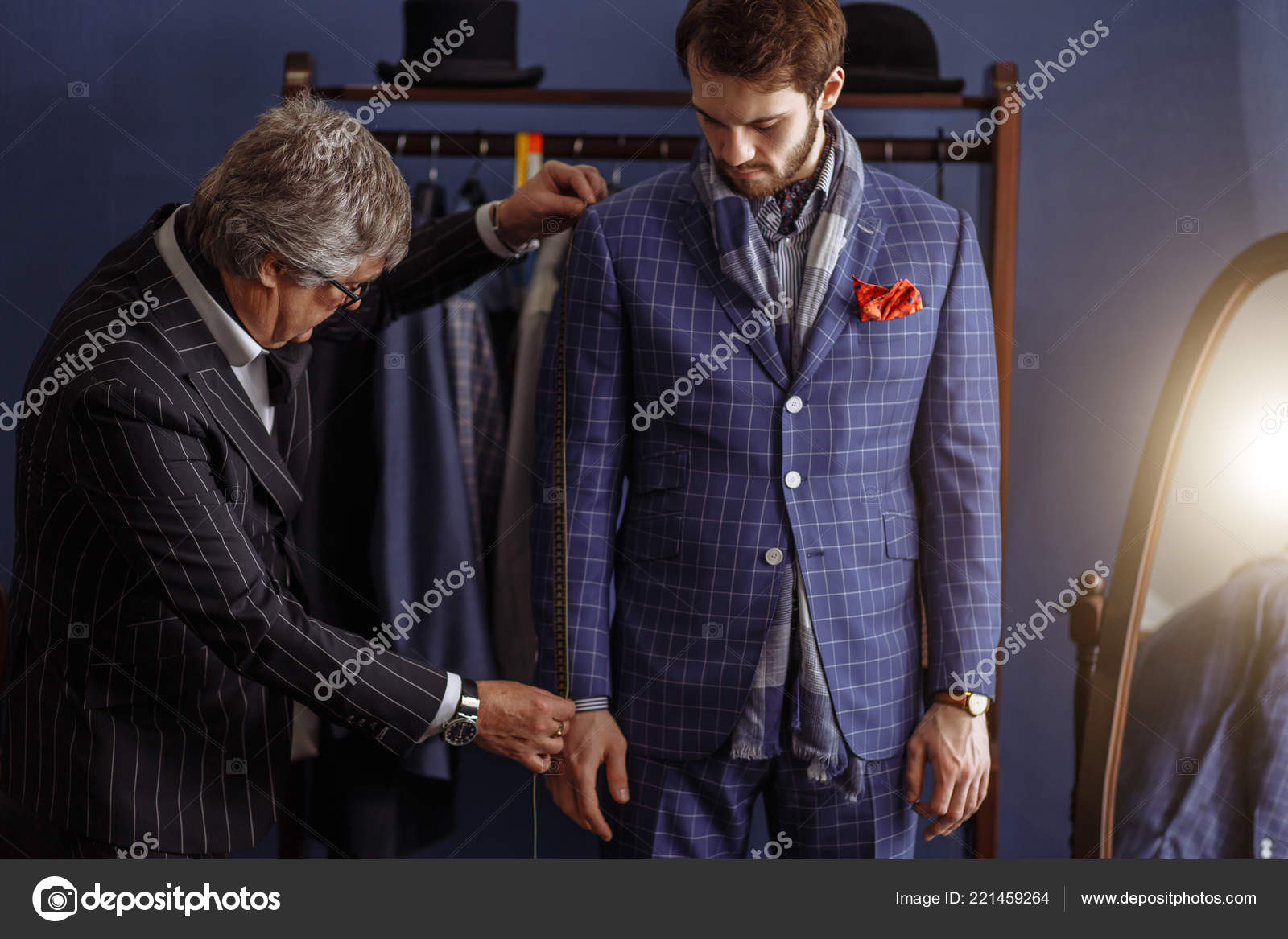 Mature professional Tailor taking measure leg measuring of client ...