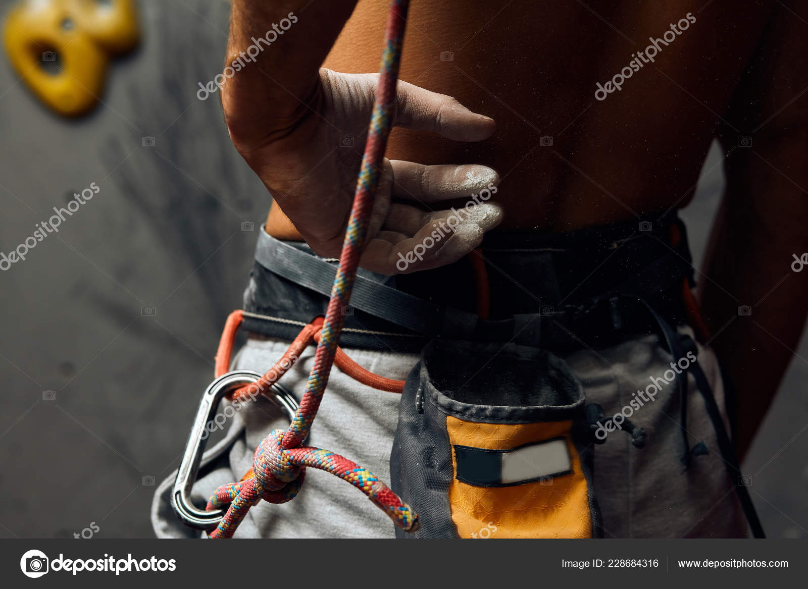 Climber s male hands with equipment during preparation for climb, close ...