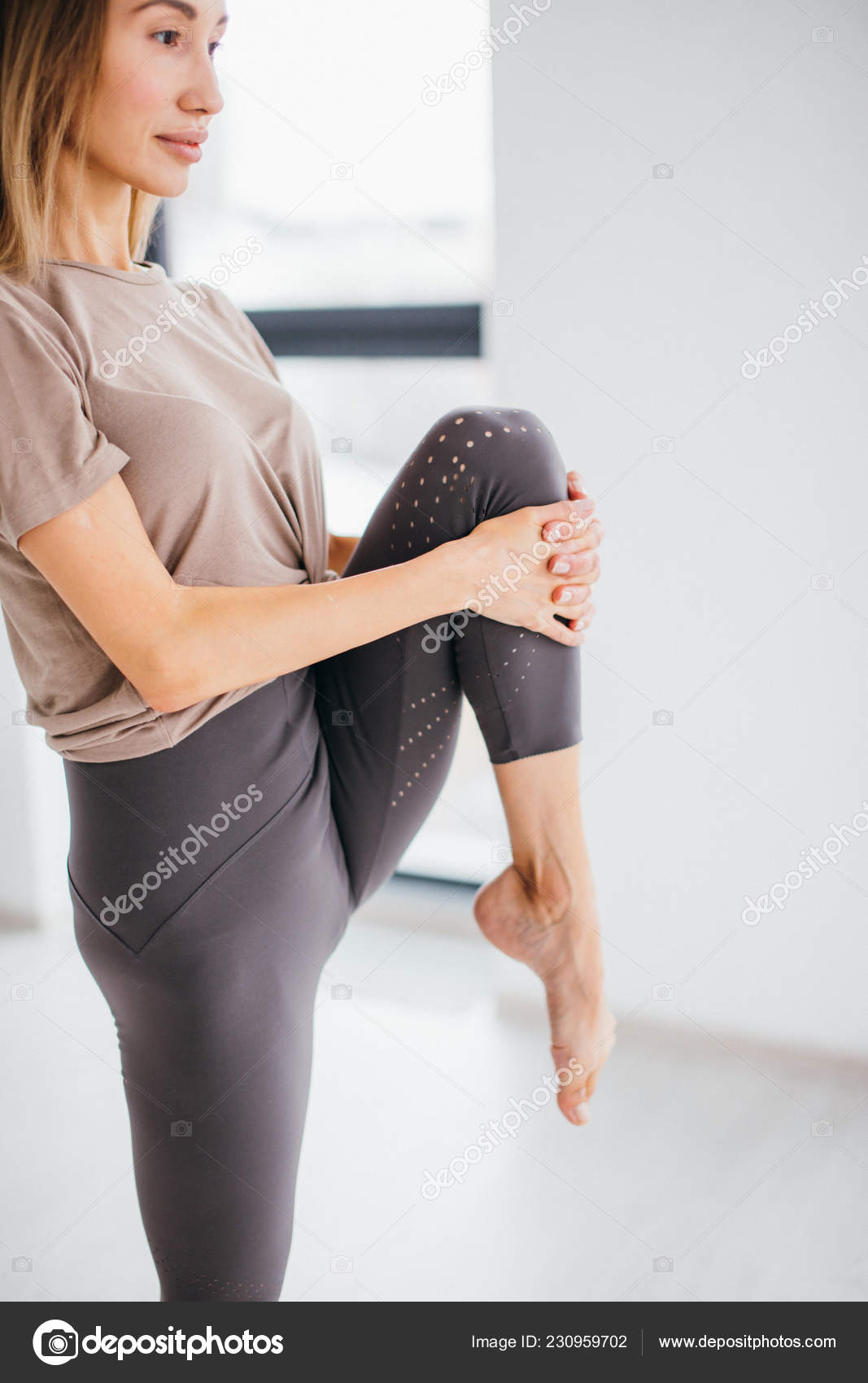 Woman standing on one leg with bent leg — Stock Photo © ufabizphoto ...