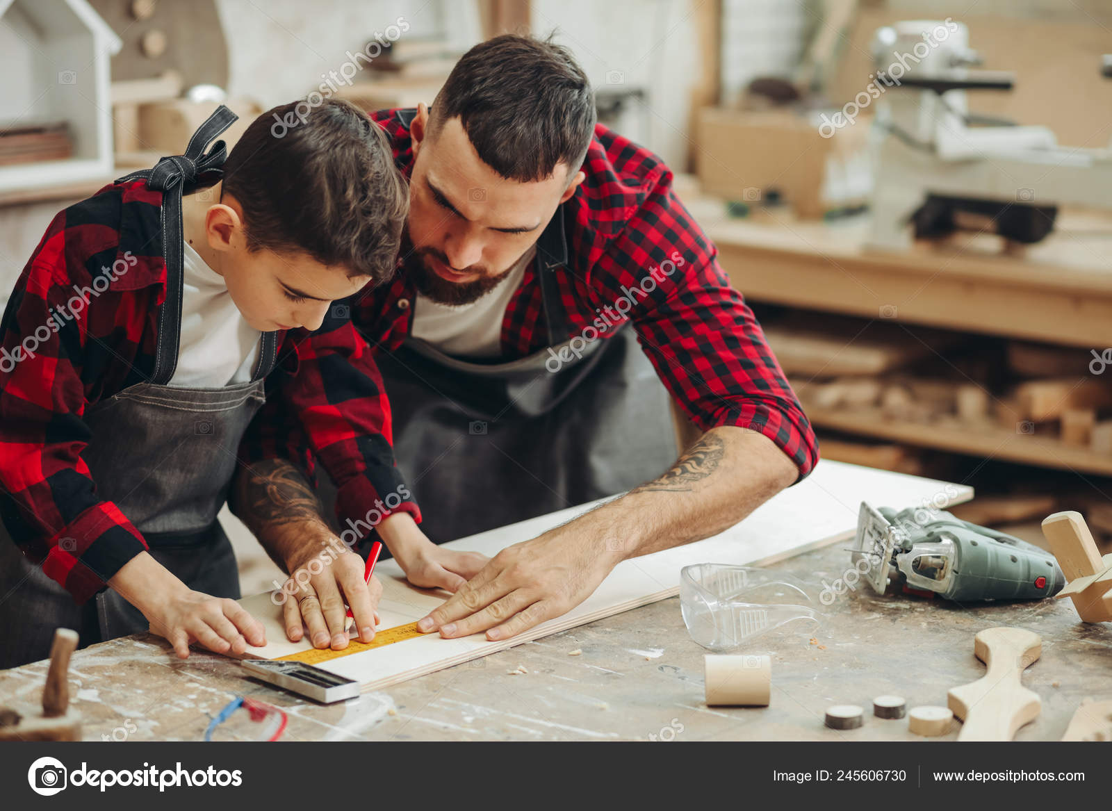 Men with ruler and pencil measuring wooden plank for work Stock Photo ...