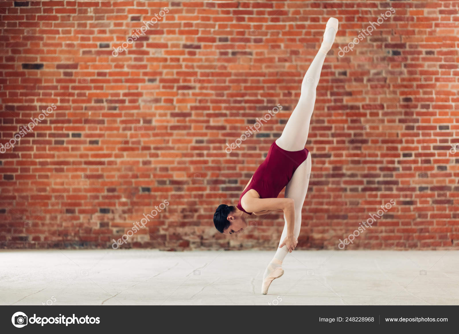 Attractive gymnast wearing special training costume doing splits. Stock ...