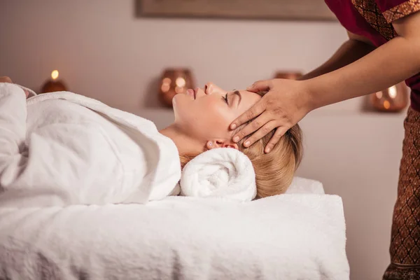 calm beautiful fair-haired woman getting facial massage - Stock Image ...
