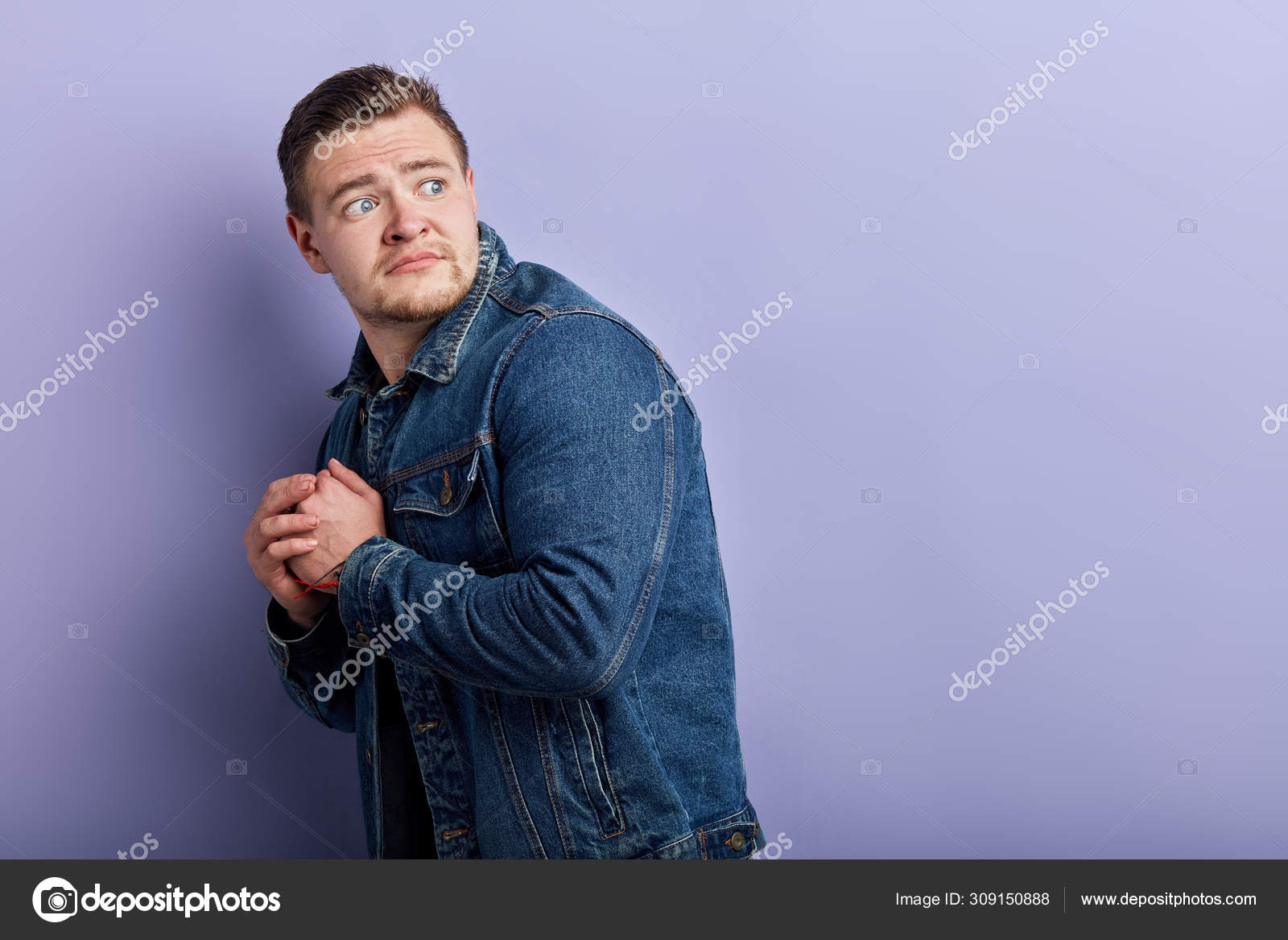 Puzzled shocked scared man standing in the cormer of studio Stock Photo ...