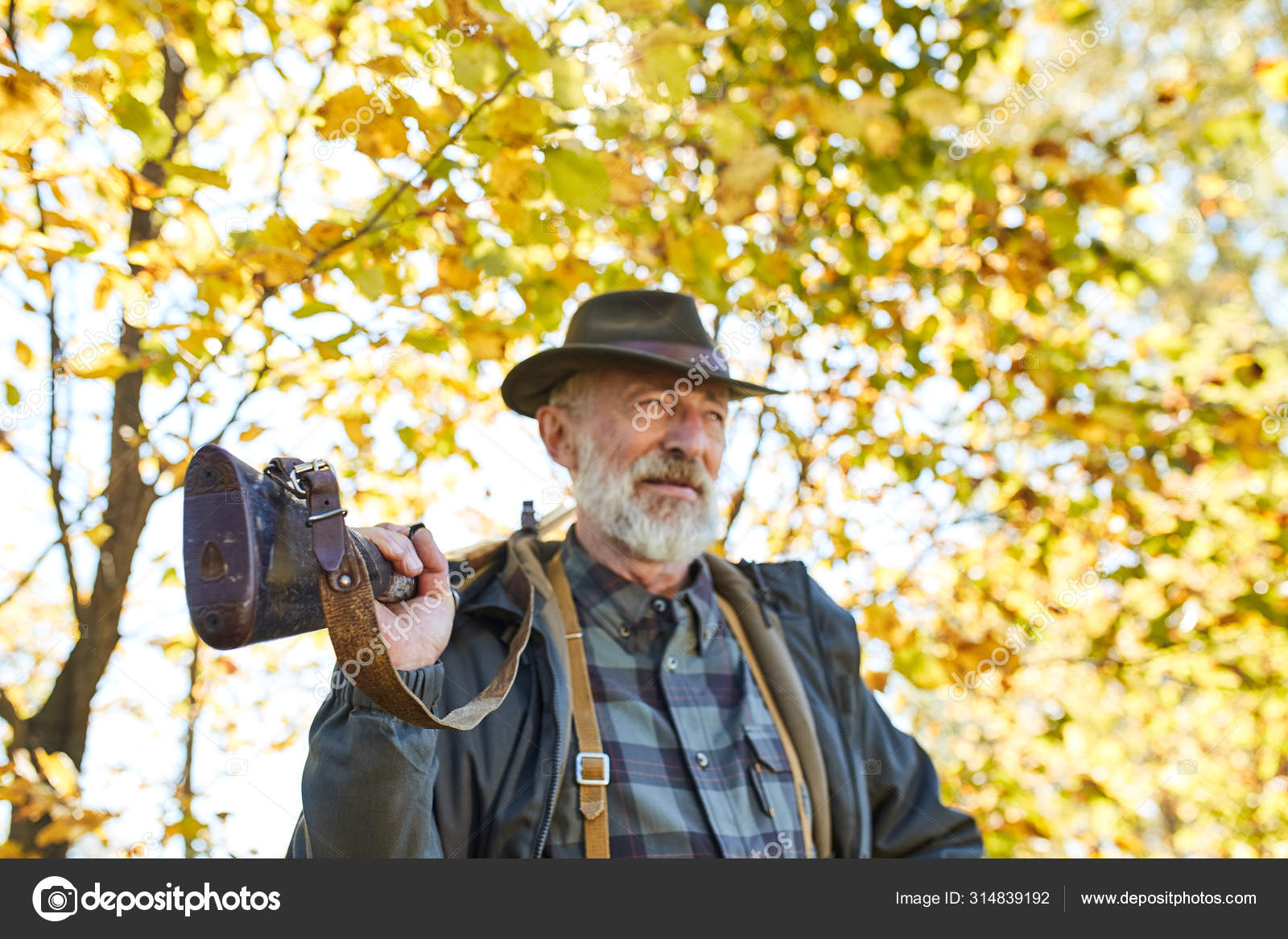 Senior hunter carrying rifle gun on shoulder — Stock Photo ...