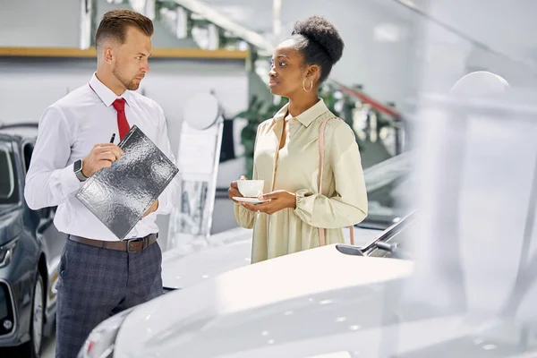 friendly salesman is talking with black customer woman - Stock Image ...
