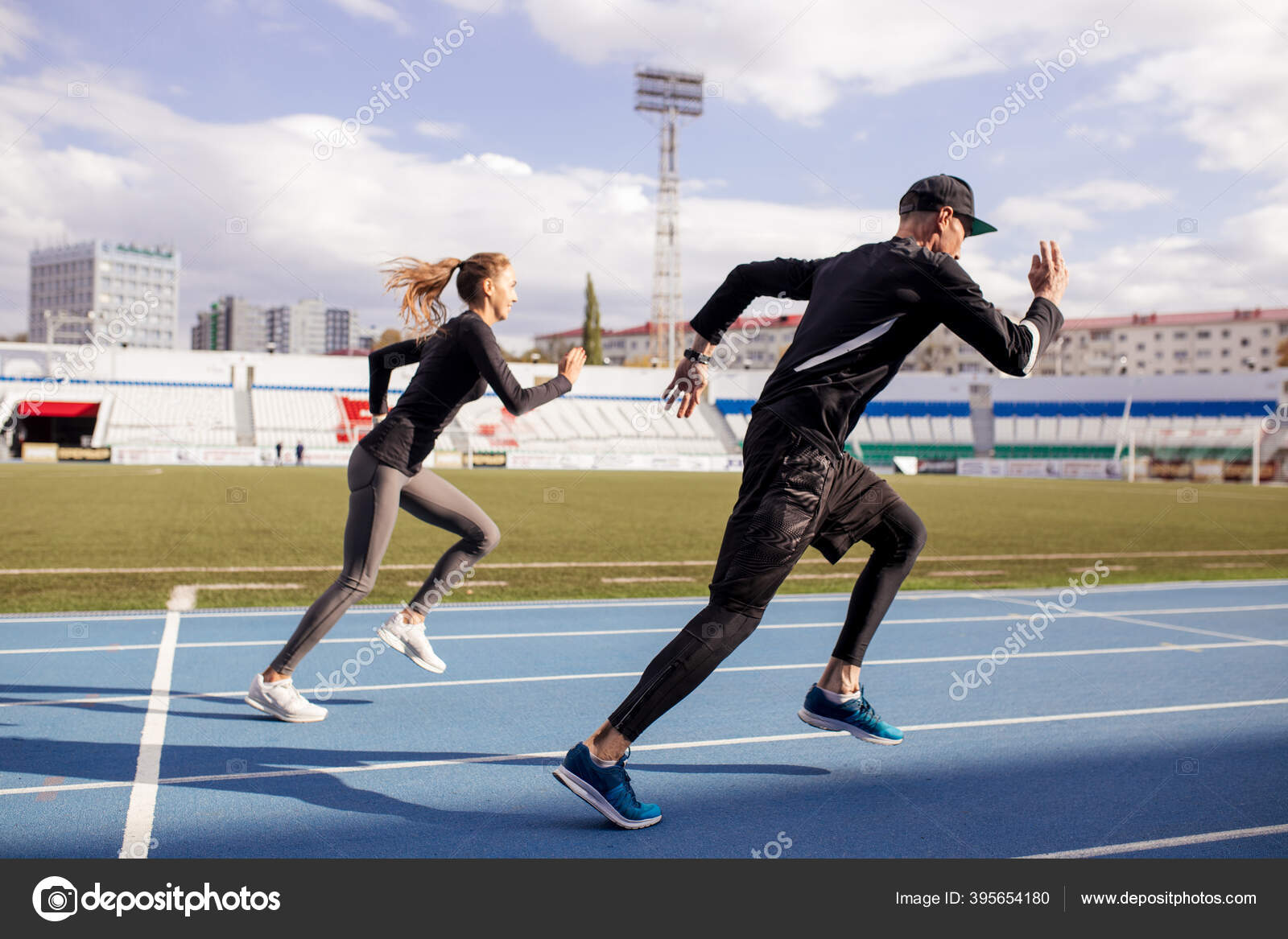 Full length side view shot. sprinting man and woman in the arena ...