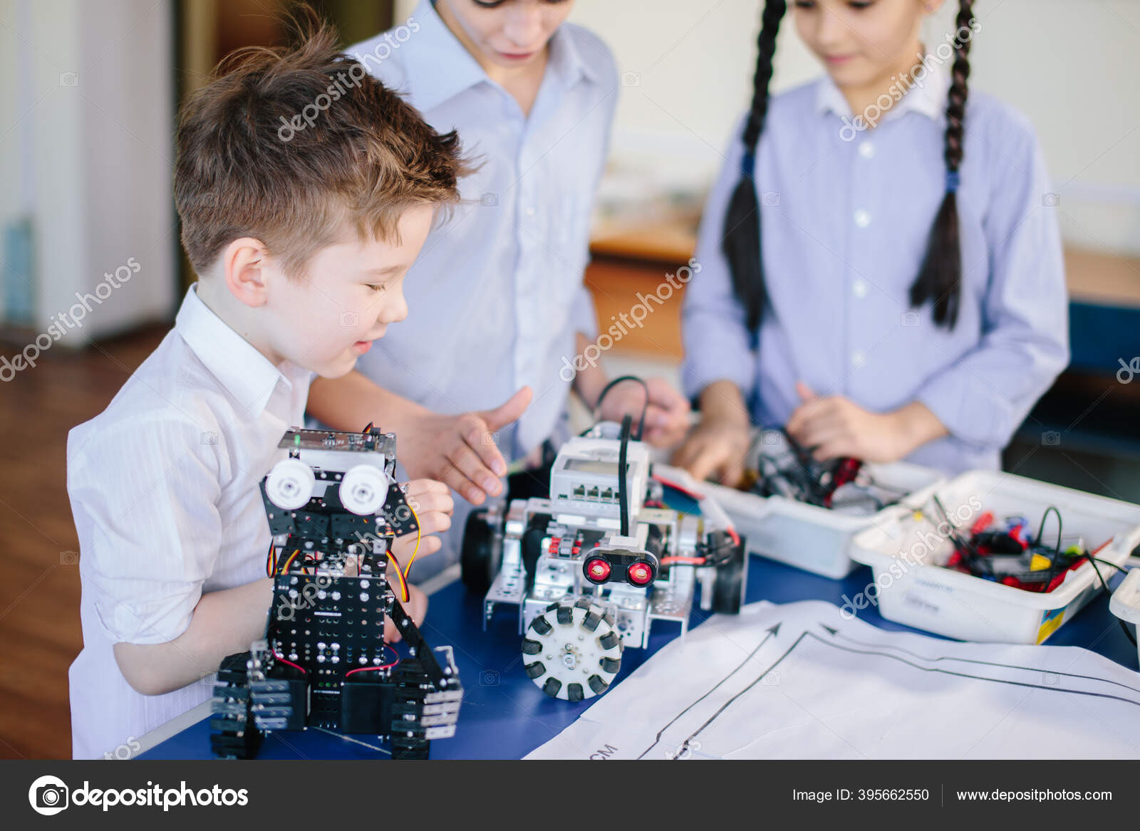 Kids playing with electrical robot while visiting robotics exhibition ...