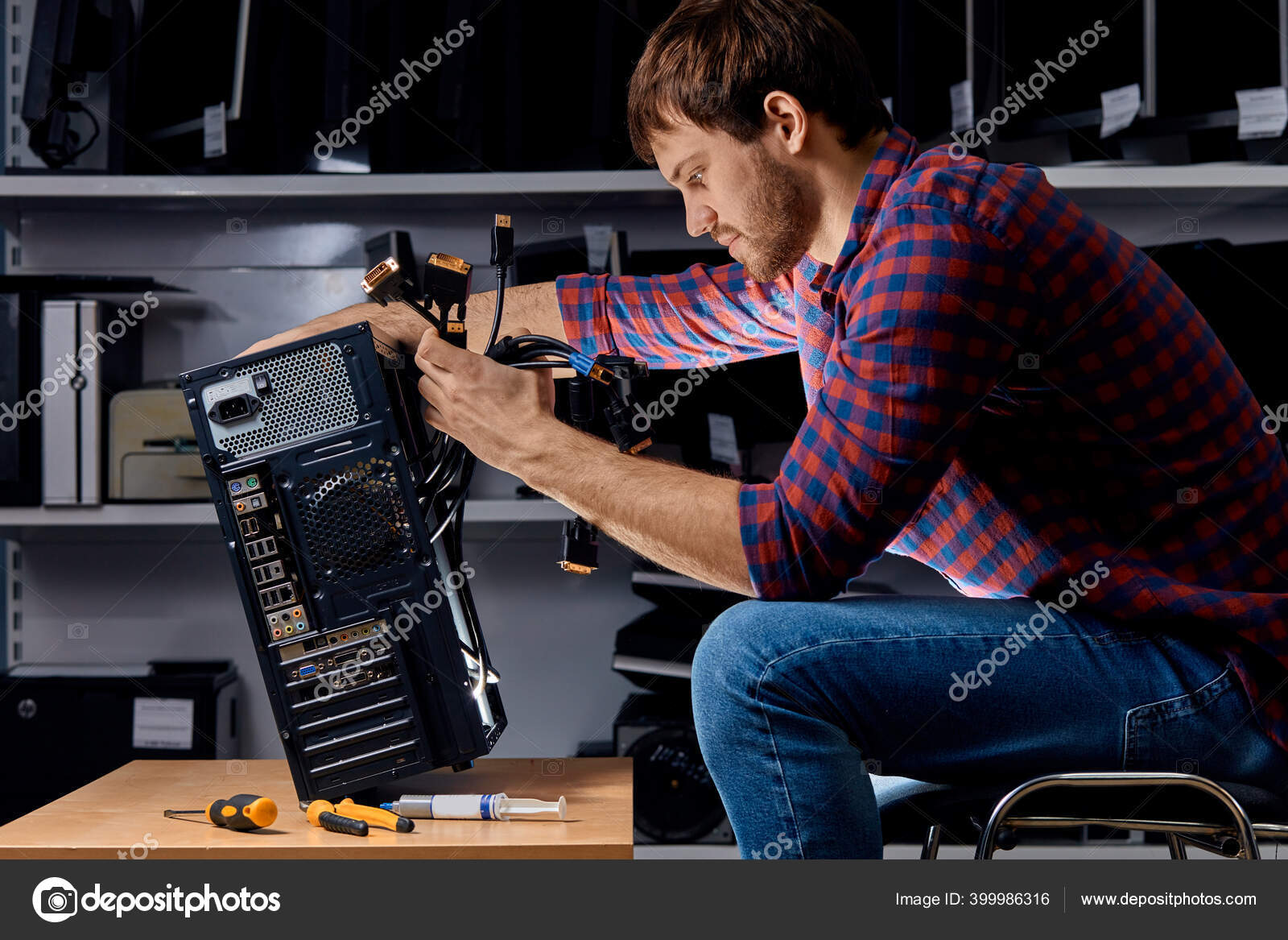 Young concentrated technician fixing a computer Stock Photo by ...