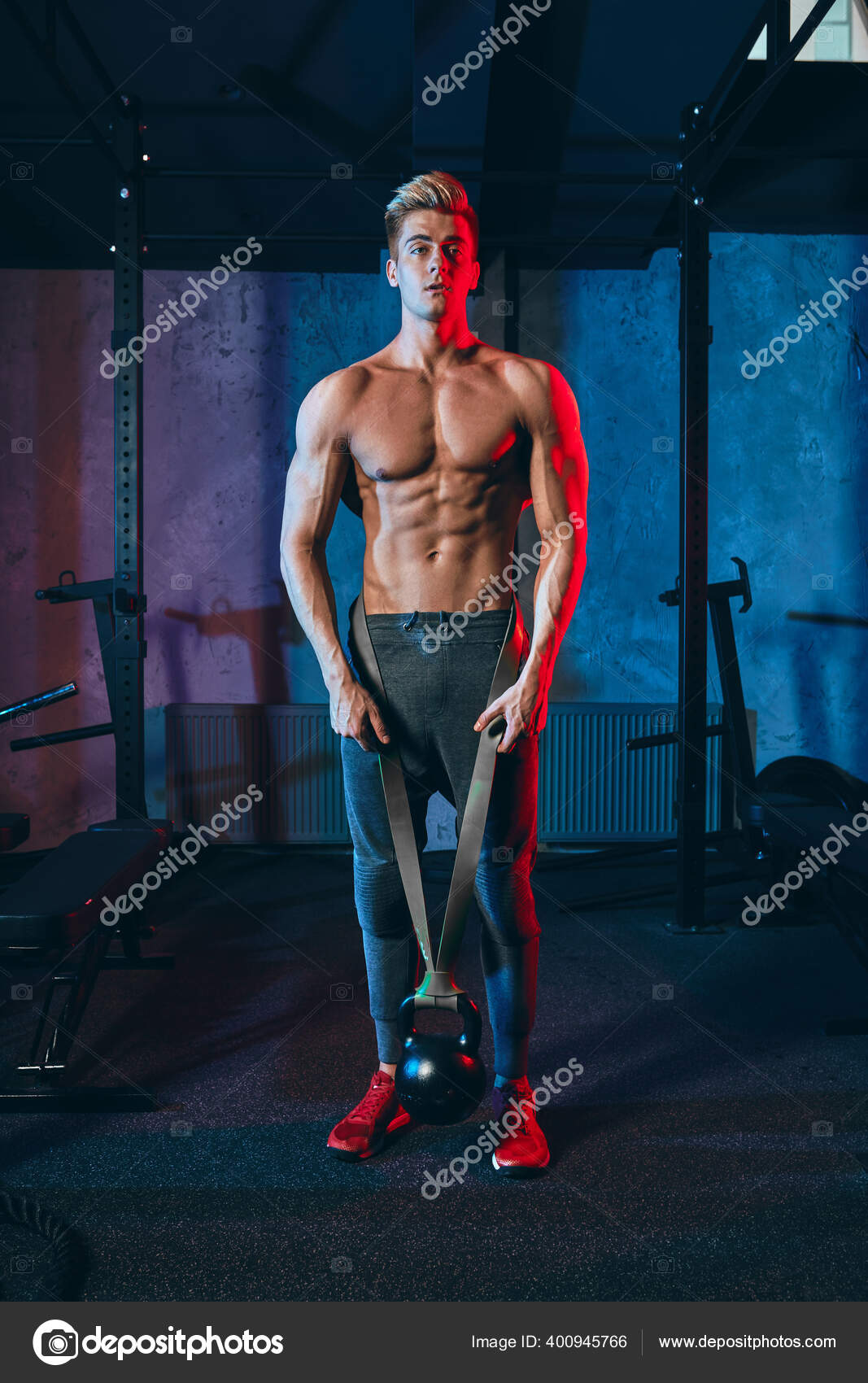 Handsome male bodybuilder in cap on brick wall background. Dark ...