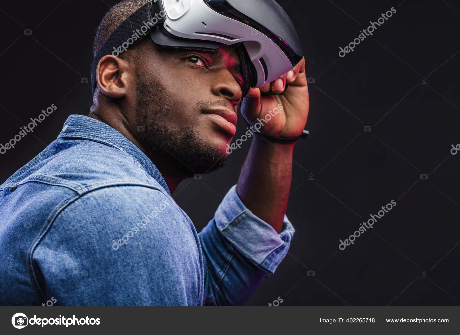 Positive african man taking off his VR glasses from his head on black ...