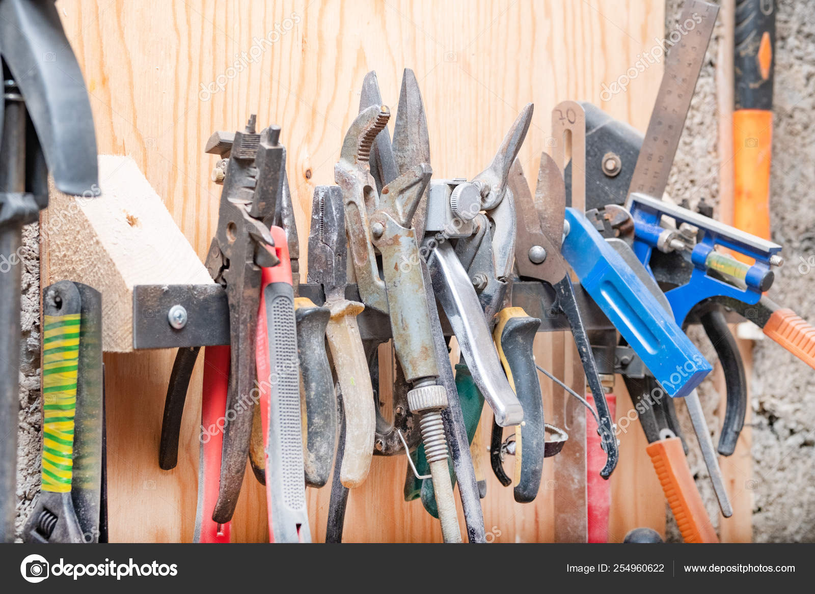 Old hand tool hanging on the barn wall, dusty and dirty old tool ...