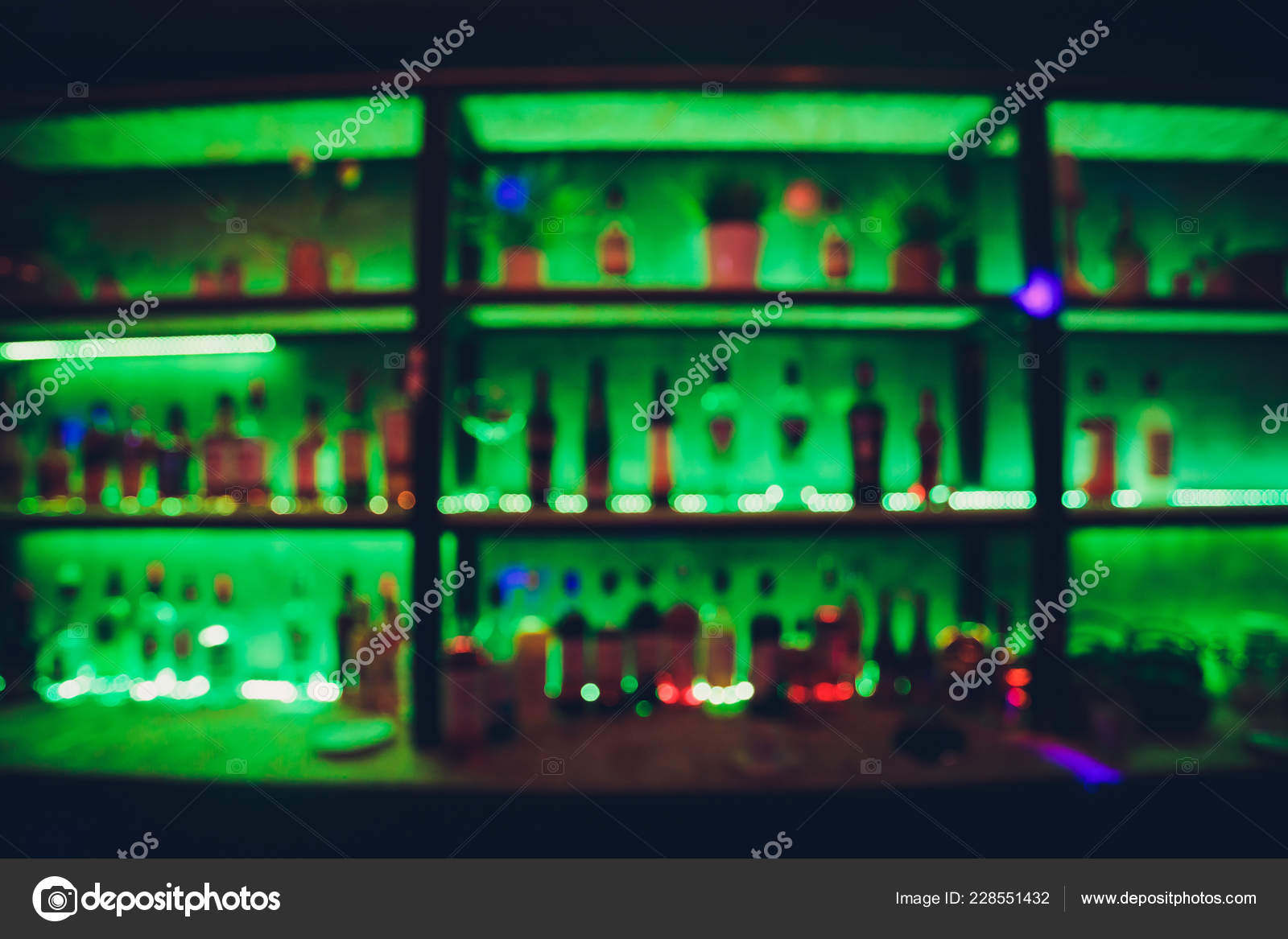 Blur alcohol drink bottle at club pub or bar in dark party night ...