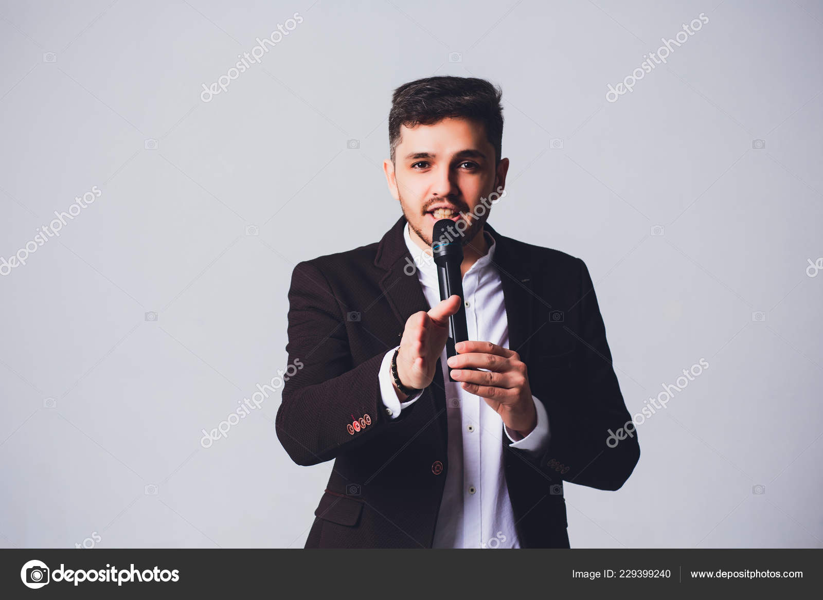 Showman interviewer with emotions. Young elegant man holding microphone ...