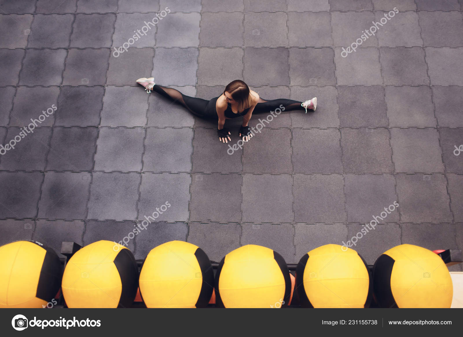 Top View Of A Fit And Sporty Girl Doing Streching Exercises For Legs