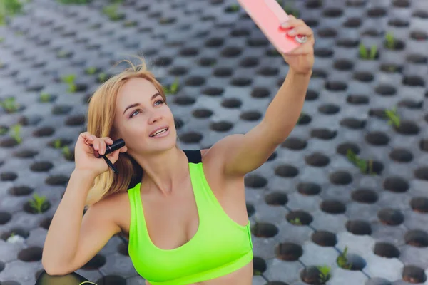 Pretty young female yoga instructor leading an online class. Young ...