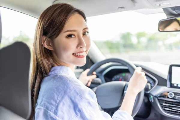 Asian female driver sit in the car and smile to you - Stock Image ...