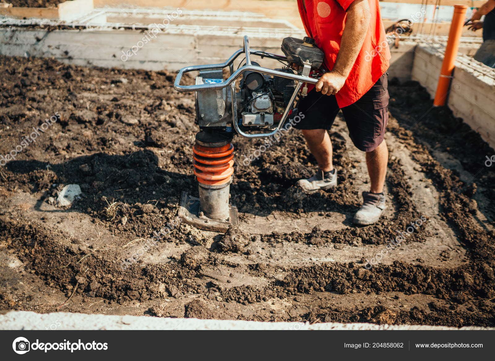 Construction Industrial Worker Compacting Soil House Foundation Using ...