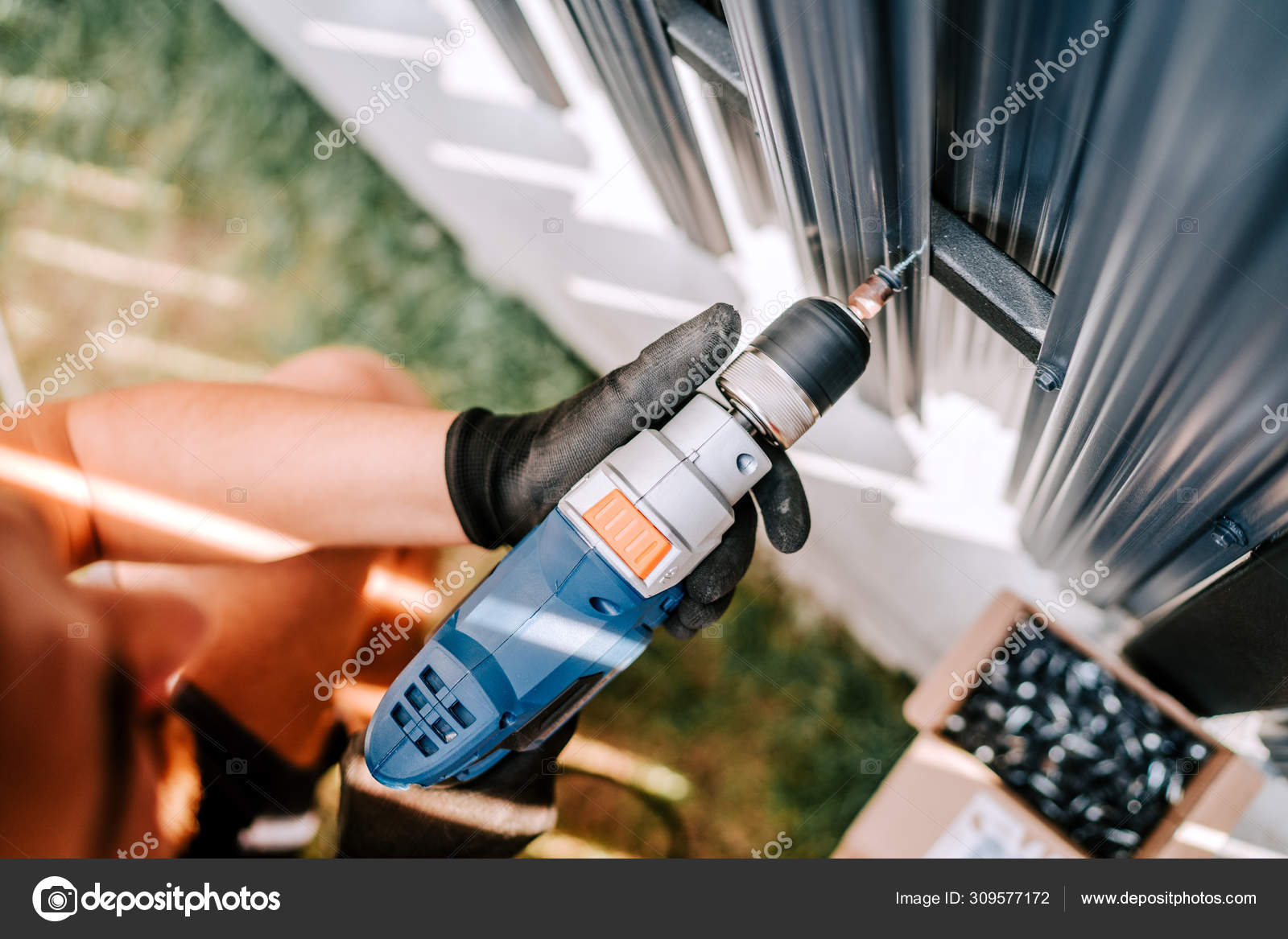 Construction worker working with an electric screwdriver on the ...