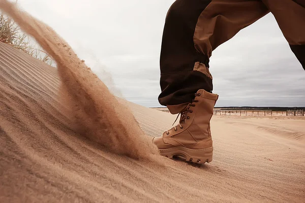 military exercises in the desert / legs in army boots, soldiers of the ...