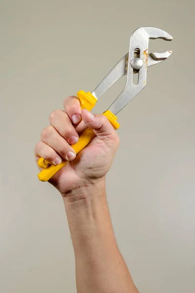 industry worker hand holding mechanical tool - Stock Image - Everypixel
