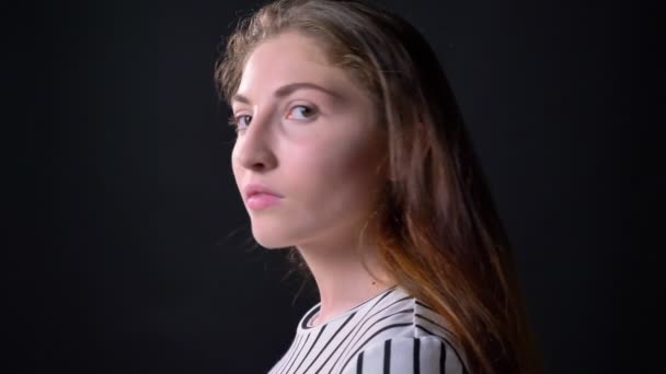 Portrait of beautiful woman turning head and looking at camera, smiling ...