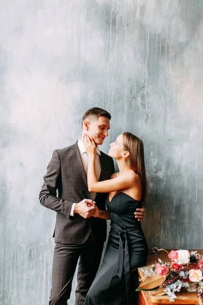 Beautiful couple in the Studio at the table. Wedding photo shoot in ...
