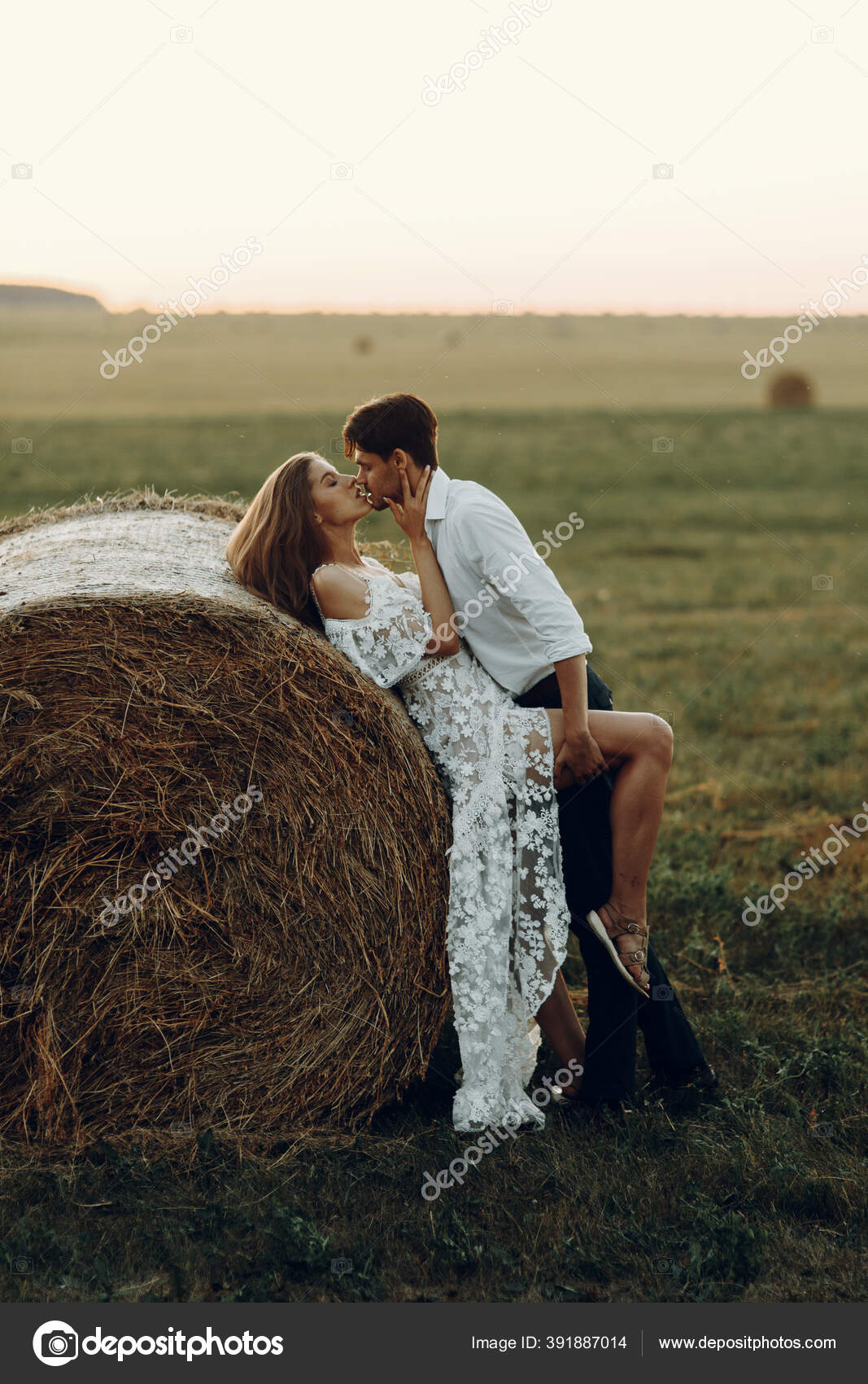 Beautiful couple with a haystack in the field. Wedding in European ...