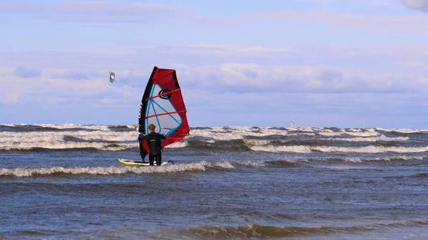 Professional surfer in the wind preparing the wind in the sea to the ...