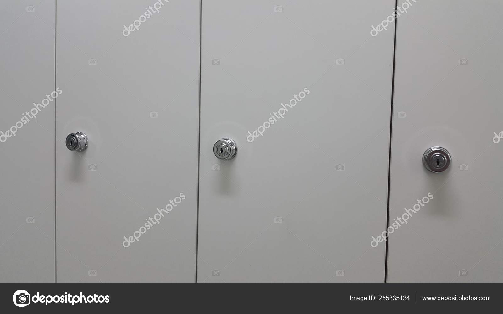 Perspective view of lockers or cupboards in a row with white doors ...