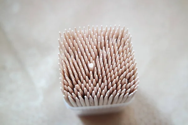 High angle top view of wood needles or wooden tooth picks arranged in a ...
