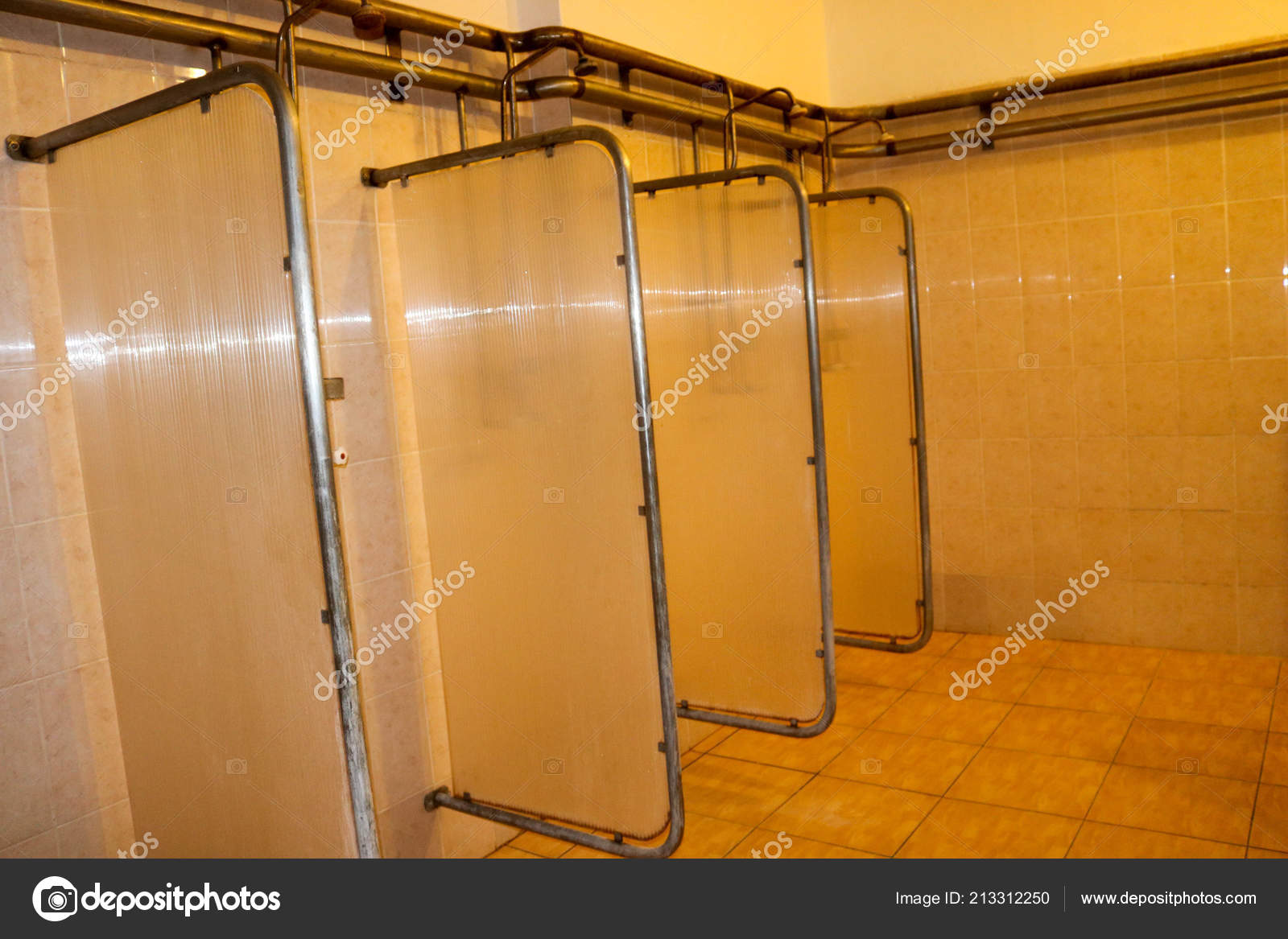 Shower cabins in the dressing rooms of workers at the industrial plant ...