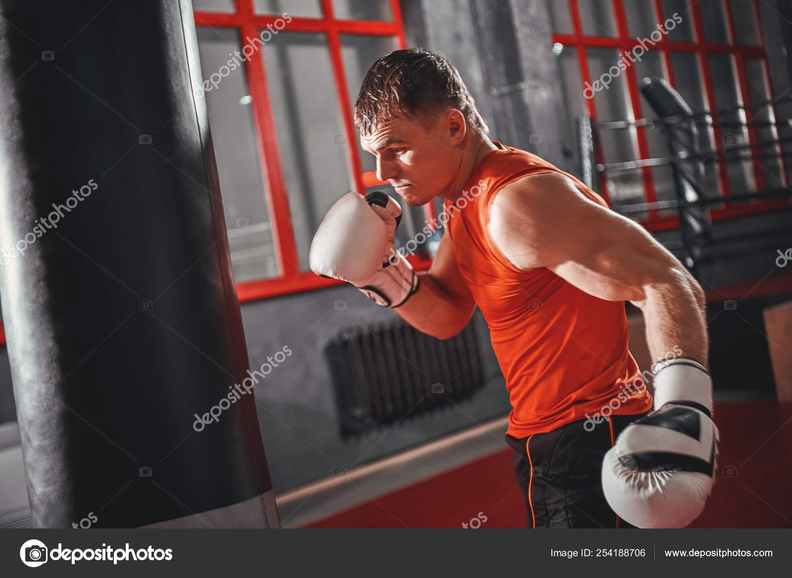 Stronger and faster. Handsome sportsman in sports clothing training on ...