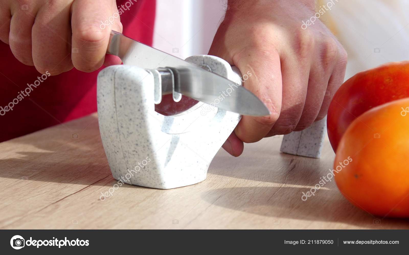 Manual sharpening of a knife in a special sharpener — Stock Photo ...