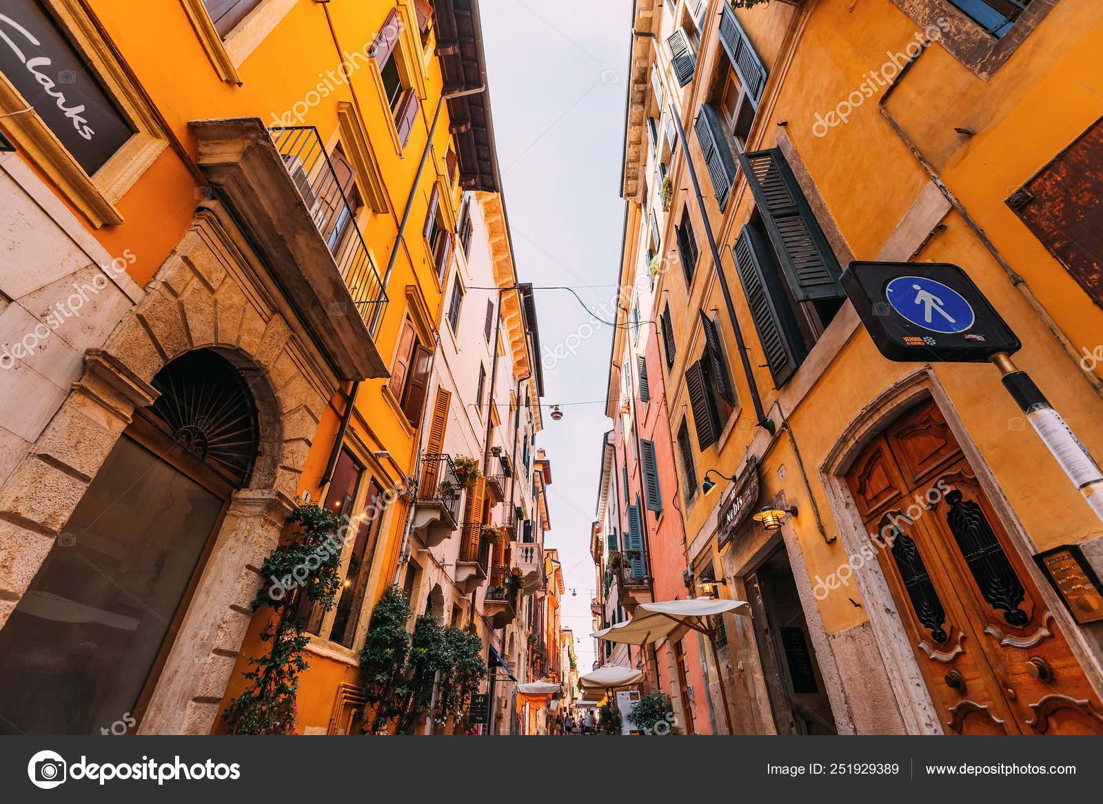 Two buildings close to each other. many windows with shutters an ...