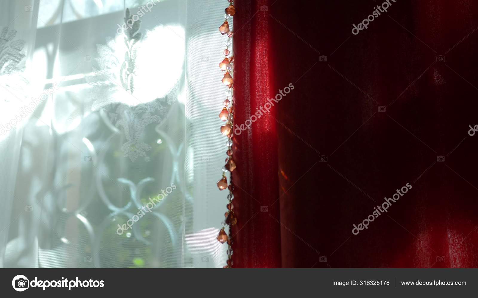 Beautiful red and white curtains on the window on a clear sunny day ...
