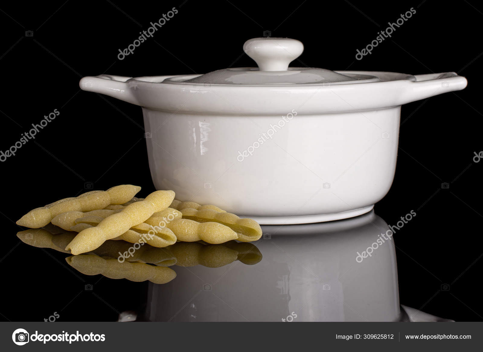 Raw cavatelli pasta isolated on black glass Stock Photo by ©PIXbank ...