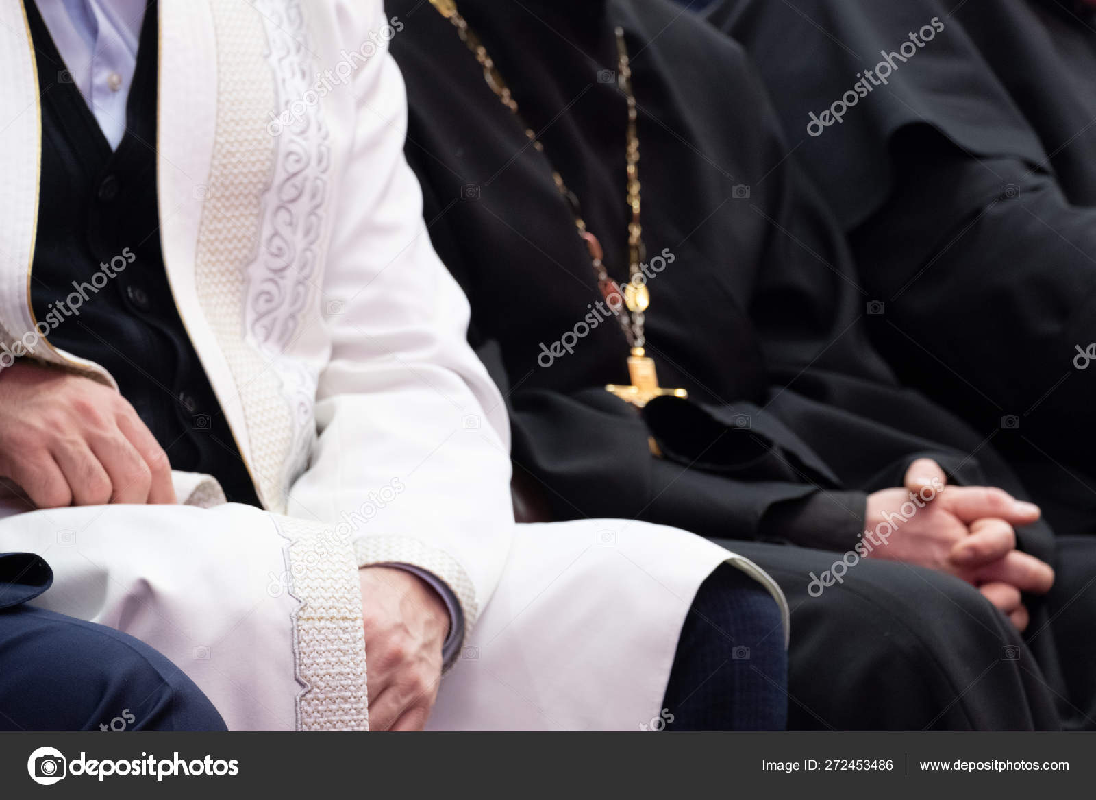 A Muslim mullah in white clothes and a Christian priest in a black ...