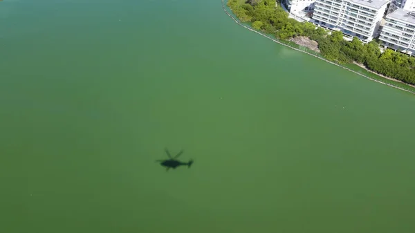 Helicopter shadow flying over water, sea or lagoon, MORE OPTIONS IN MY ...