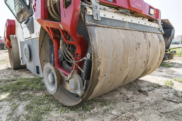 Red Heavy Vibration roller at asphalt pavement works. Road repairing ...