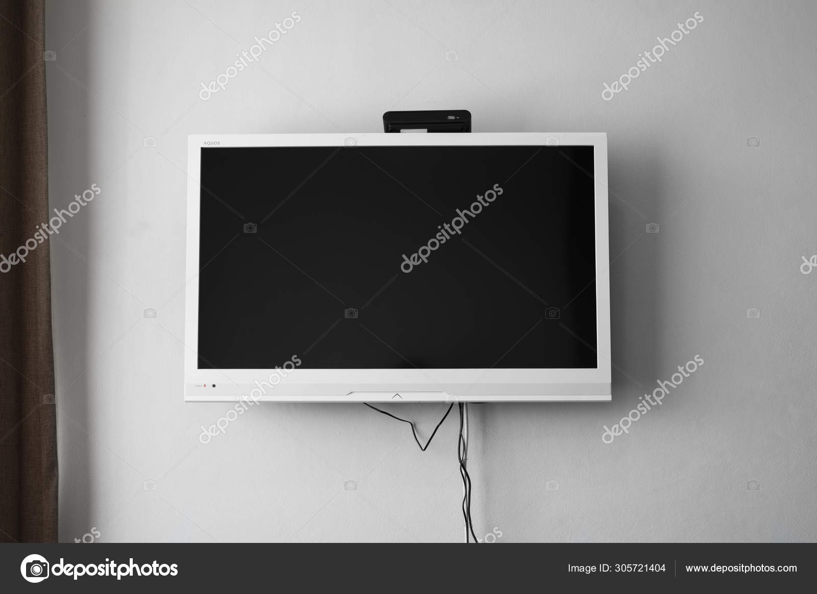LCD or LED tv screen hanging on the wall with a tv tuner in room for ...