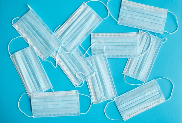 Medical protective masks on a blue background. Disposable 3-ply medical ...