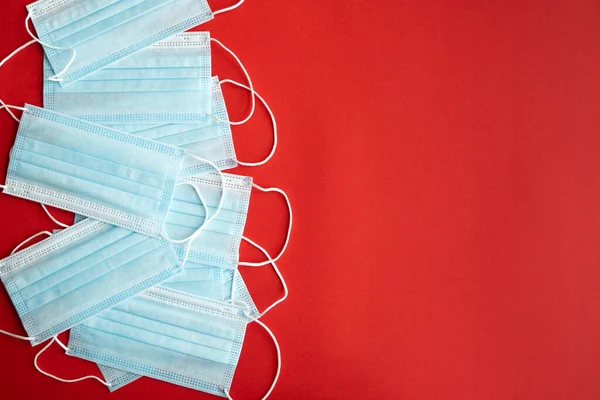 Medical protective masks on a red background. Disposable 3-ply medical ...