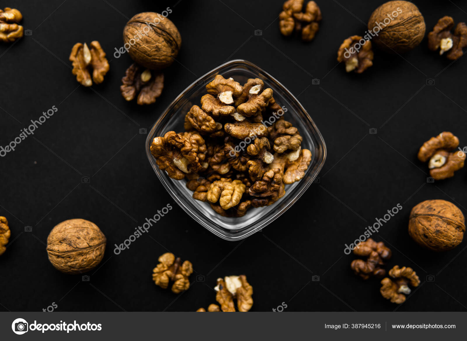 Walnut in a small plate with scattered shelled nuts which standing on a ...